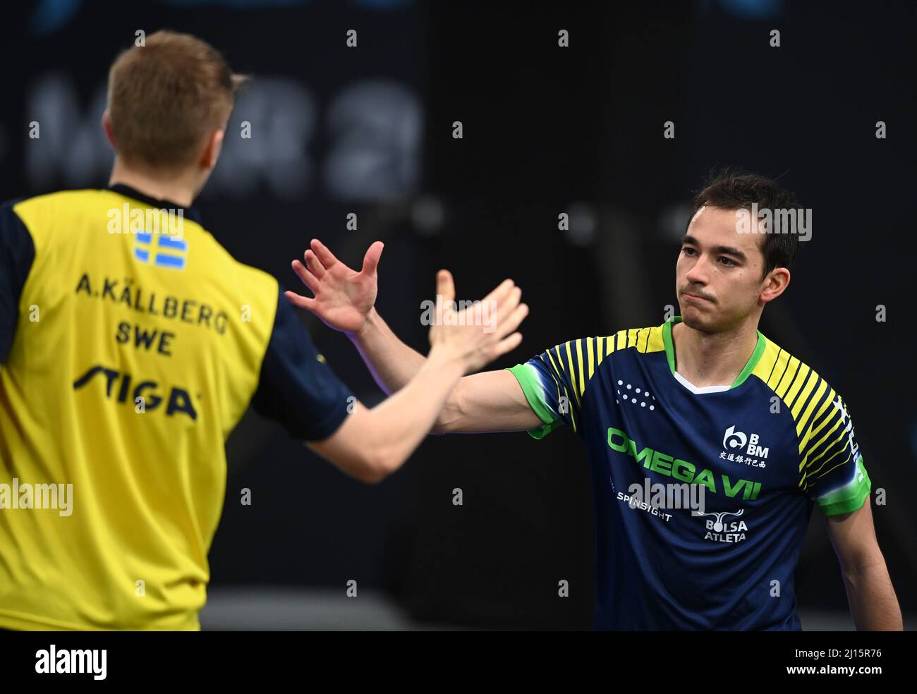 Doha, Qatar. 22nd Mar, 2022. Hugo Calderano (R) of Brazil shakes hands ...