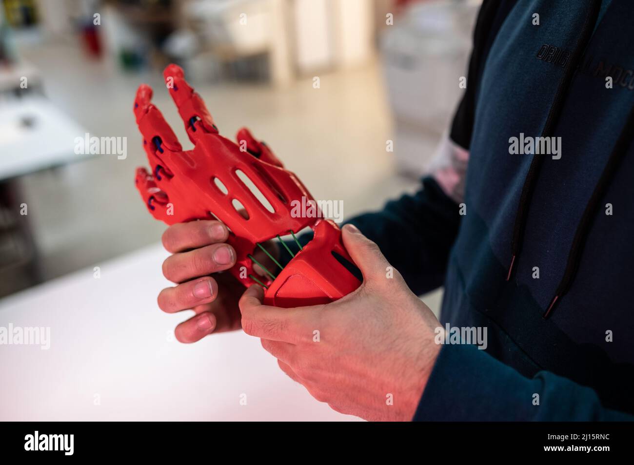 Man holding a 3D printed plastic hand prosthesis Stock Photo - Alamy