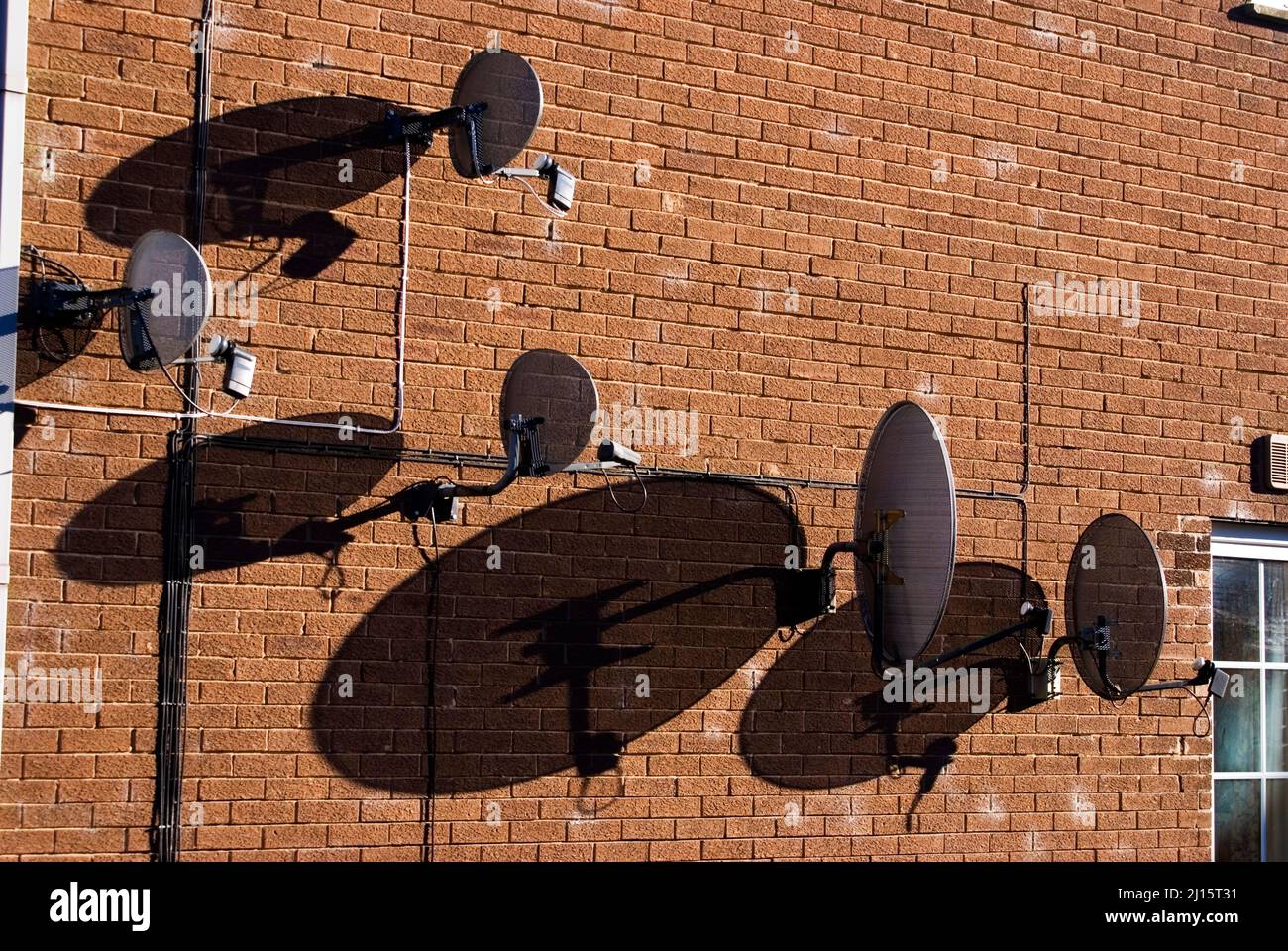 Satellite dishes on a wall Stock Photo - Alamy