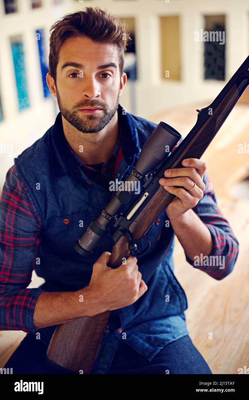 Getting ready for the big hunt. Portrait of a hunter posing with his ...