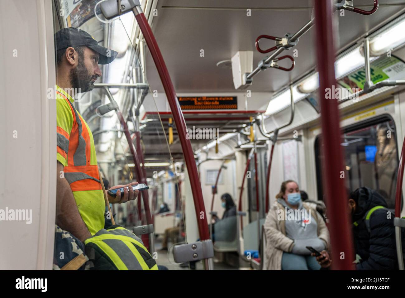 A Construction Worker Without A Facemask Stands Inside The Subway a-construction-worker-without-a-facemask-stands-inside-the-subway