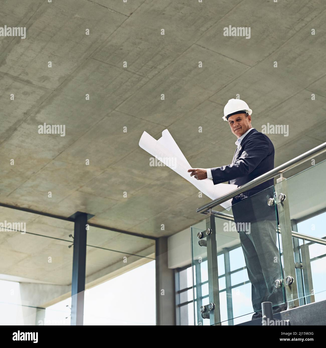 Going through the plans like the boss he is. Portrait of a cheerful ...