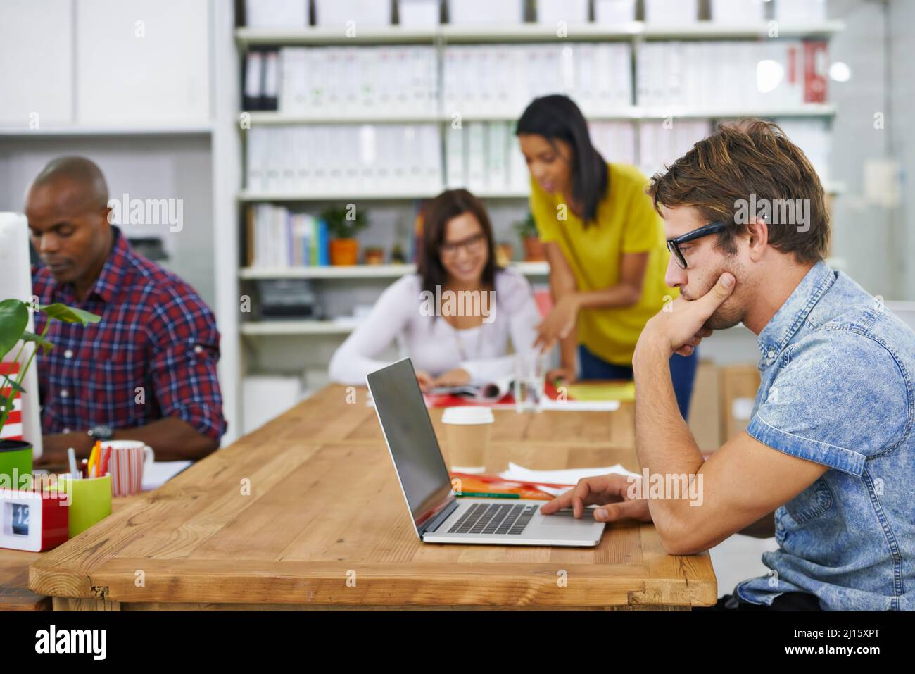 Bringing ideas into focus. Shot of a young designers at work in an ...