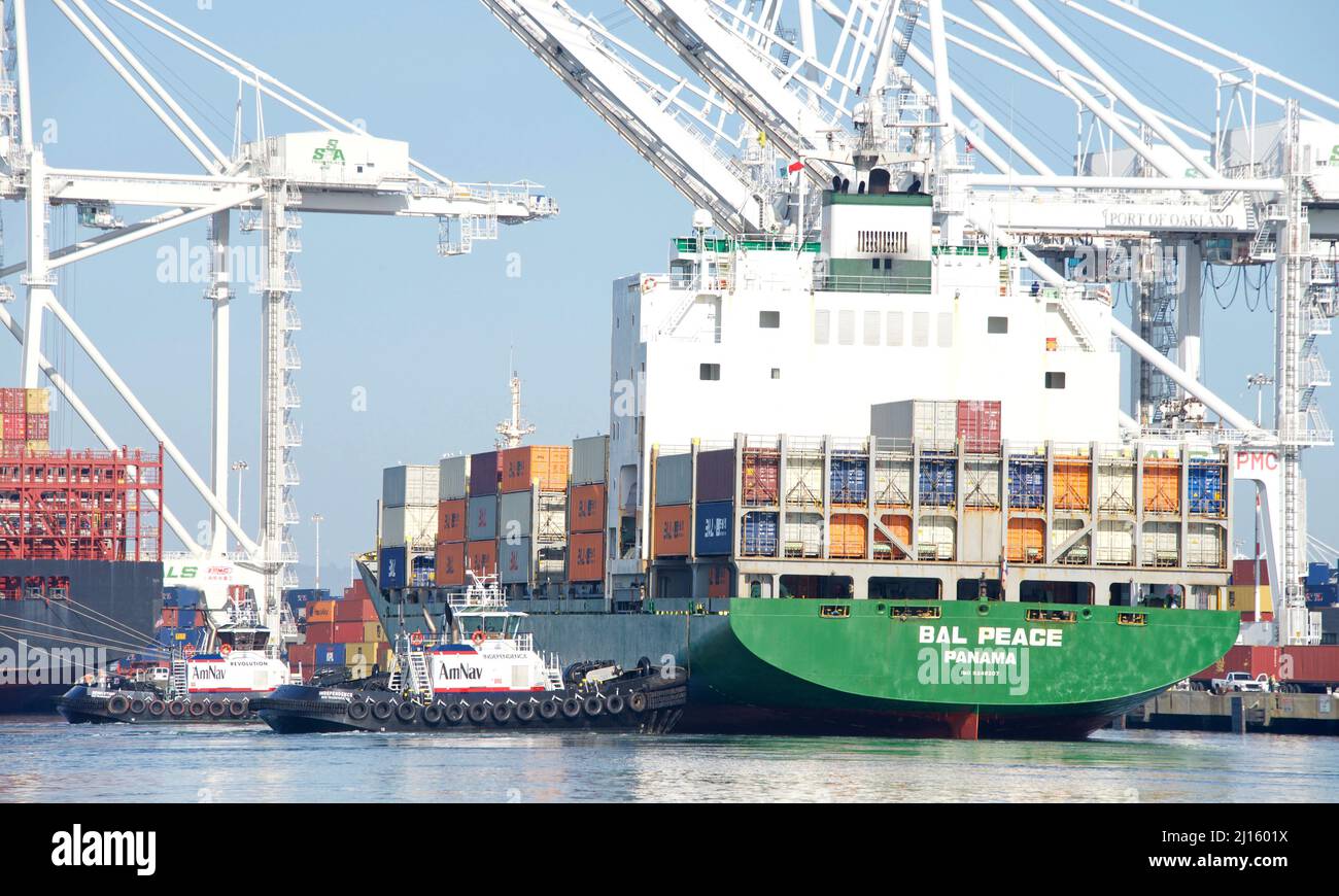Oakland, CA - March 16, 2022: Tugboats assisting Evergreen cargo ship ...