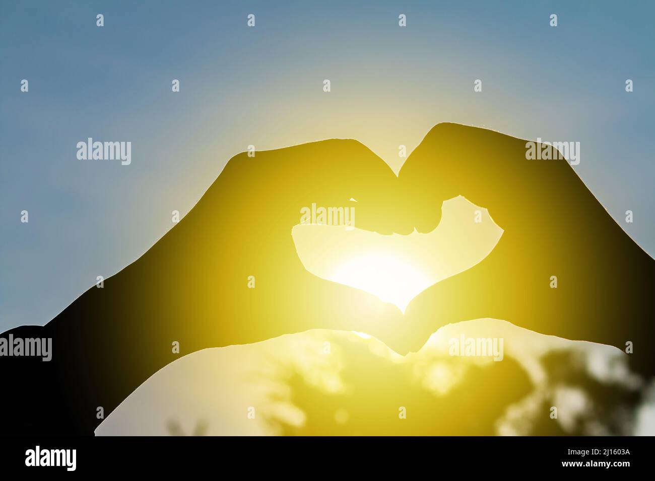 love shape hand silhouette at sunset background Stock Photo - Alamy