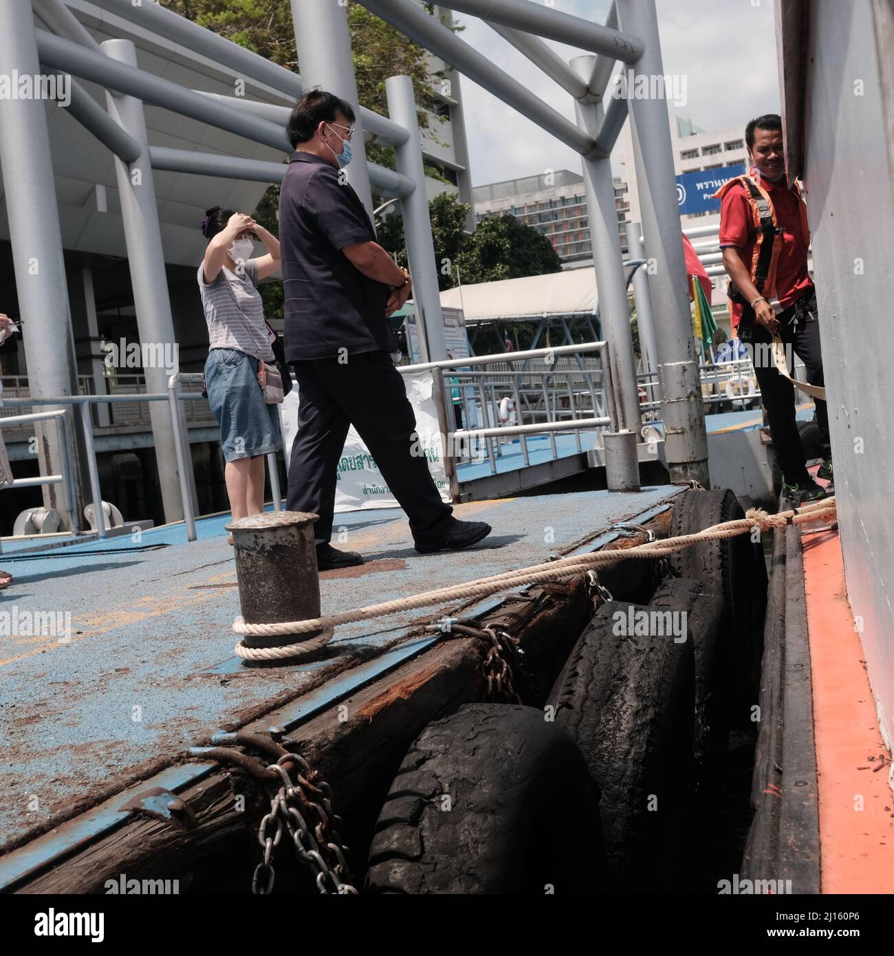 Worker on Orange Flag Express Boat Seaman Boatswain man on the ropes ...