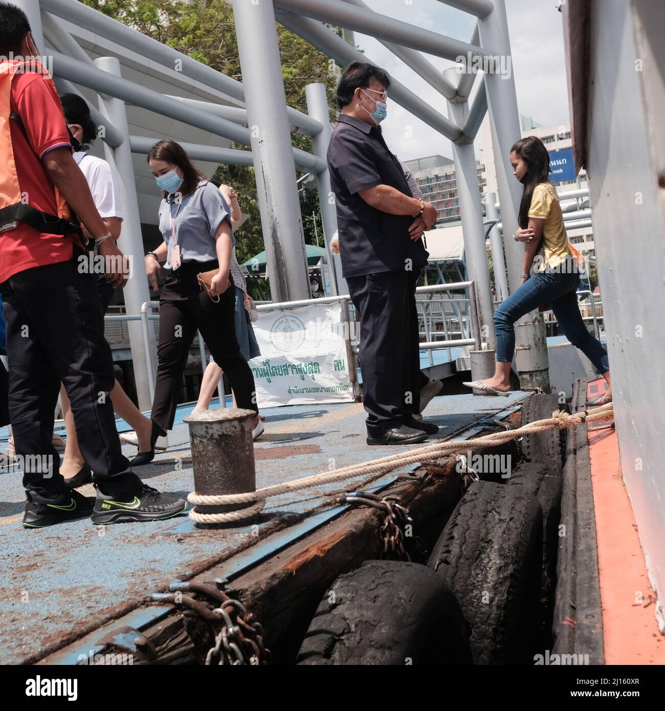 Worker on Orange Flag Express Boat Seaman Boatswain man on the ropes ...