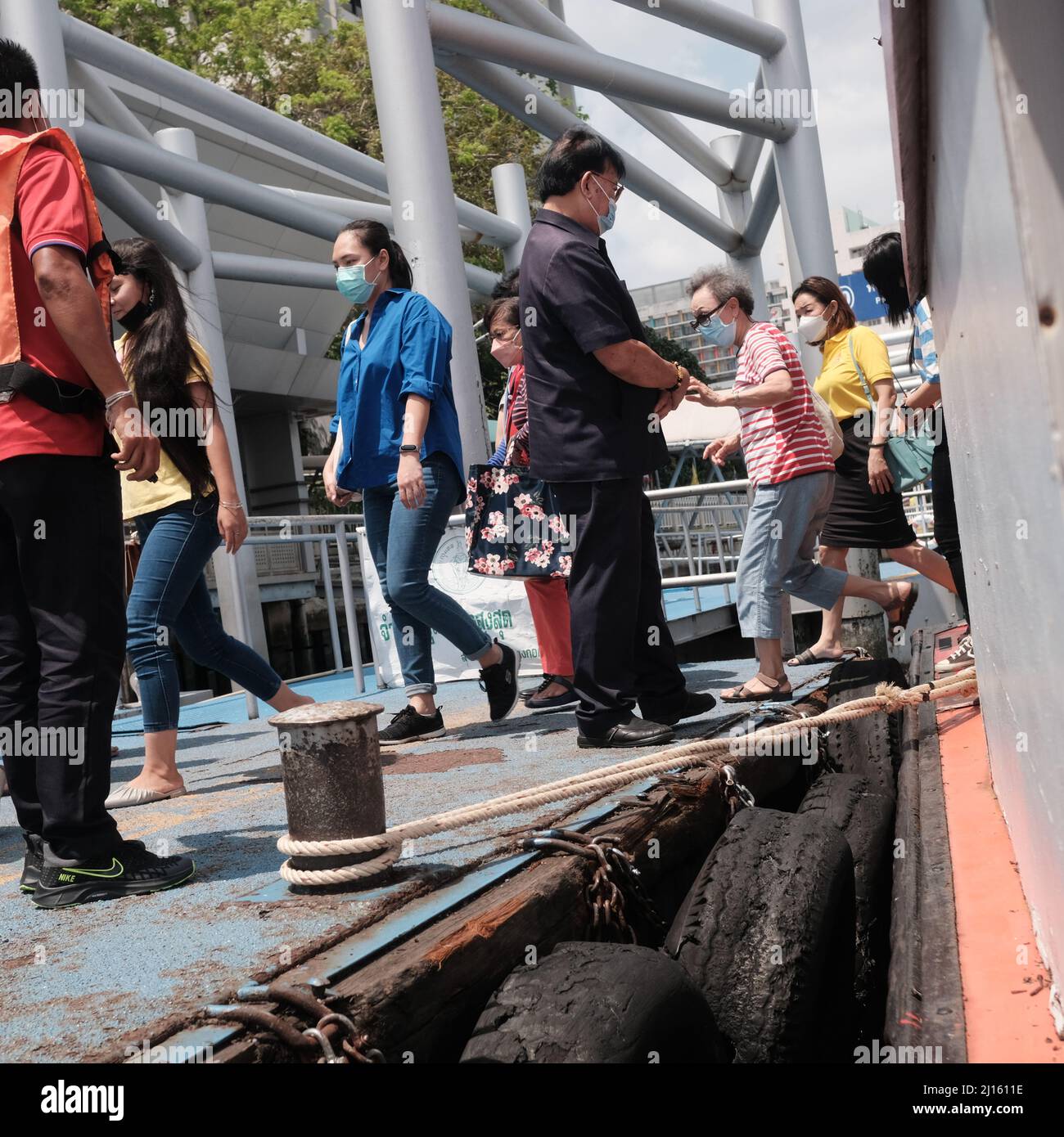 Worker on Orange Flag Express Boat Seaman Boatswain man on the ropes ...