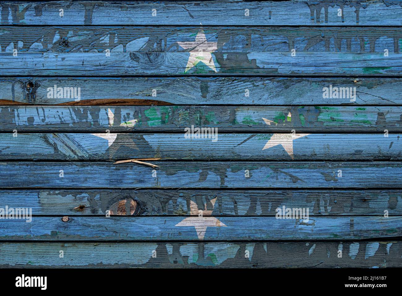 The national flag of Federal States of Micronesia is painted on uneven ...