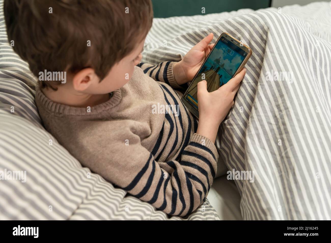 Child playing video game on cellphone, children entertainment Stock ...