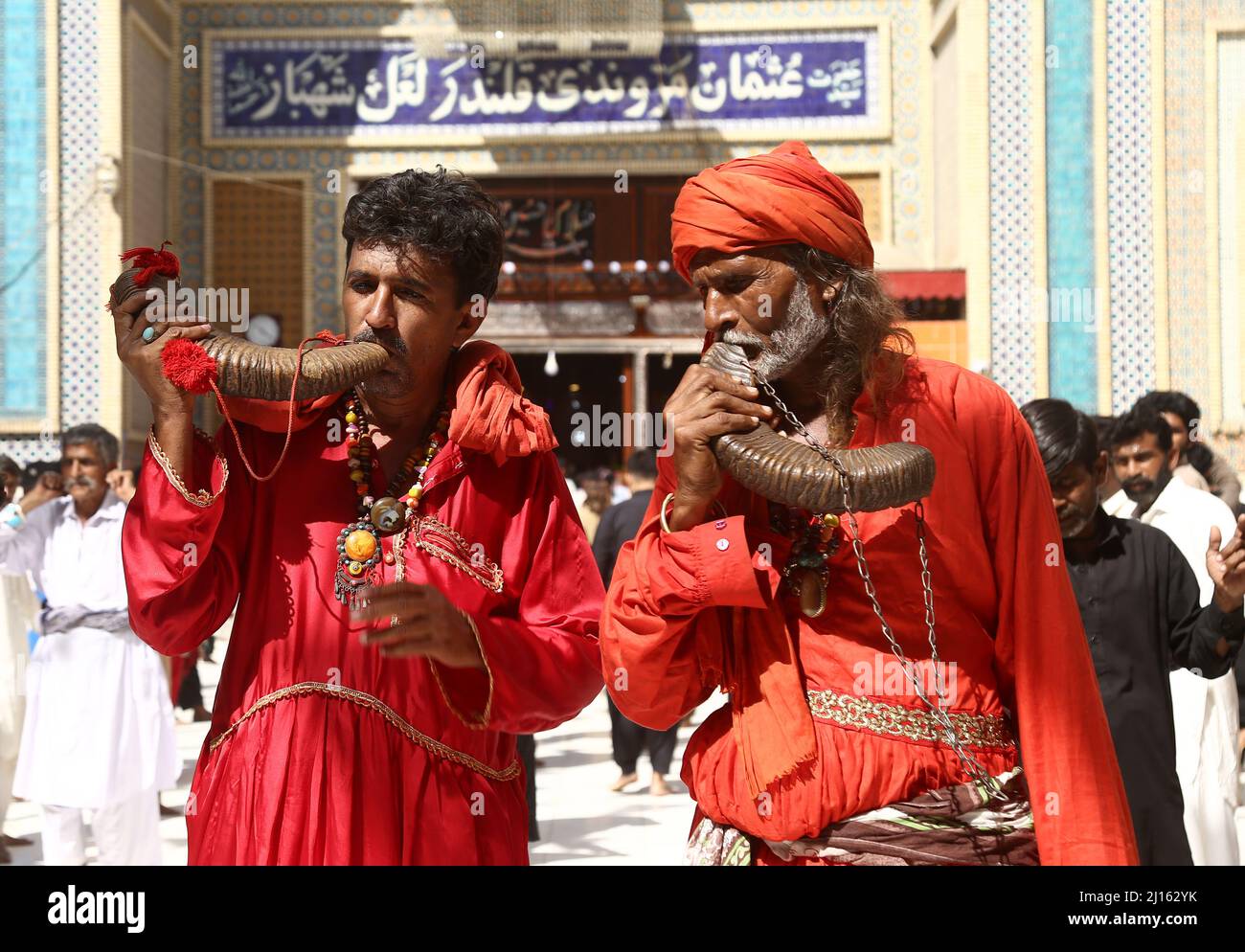 Sehwan, Pakistan. 22nd Mar, 2022. Devotees play there traditional ...