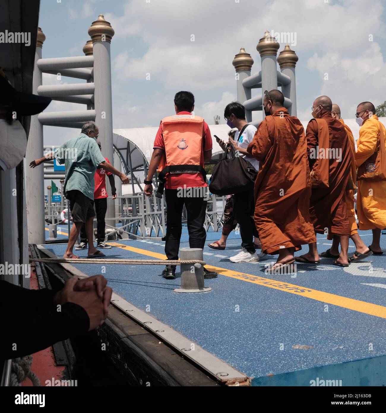 Worker on Orange Flag Express Boat Seaman Boatswain man on the ropes ...