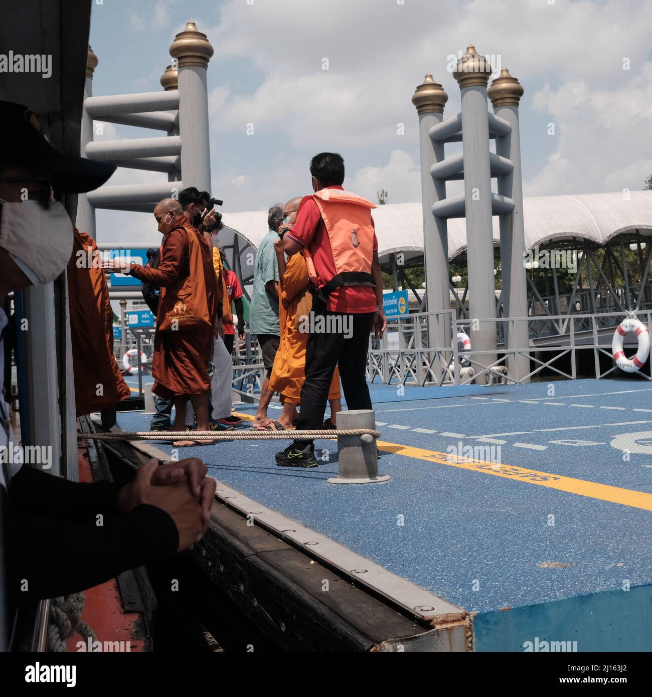 Worker on Orange Flag Express Boat Seaman Boatswain man on the ropes ...