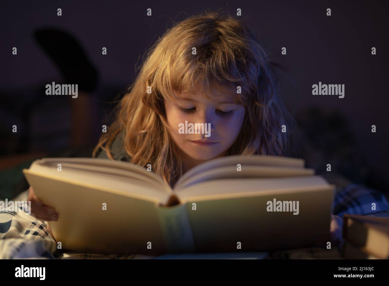 Cute little boy reading book. Child with open book. Homeschool lesson ...