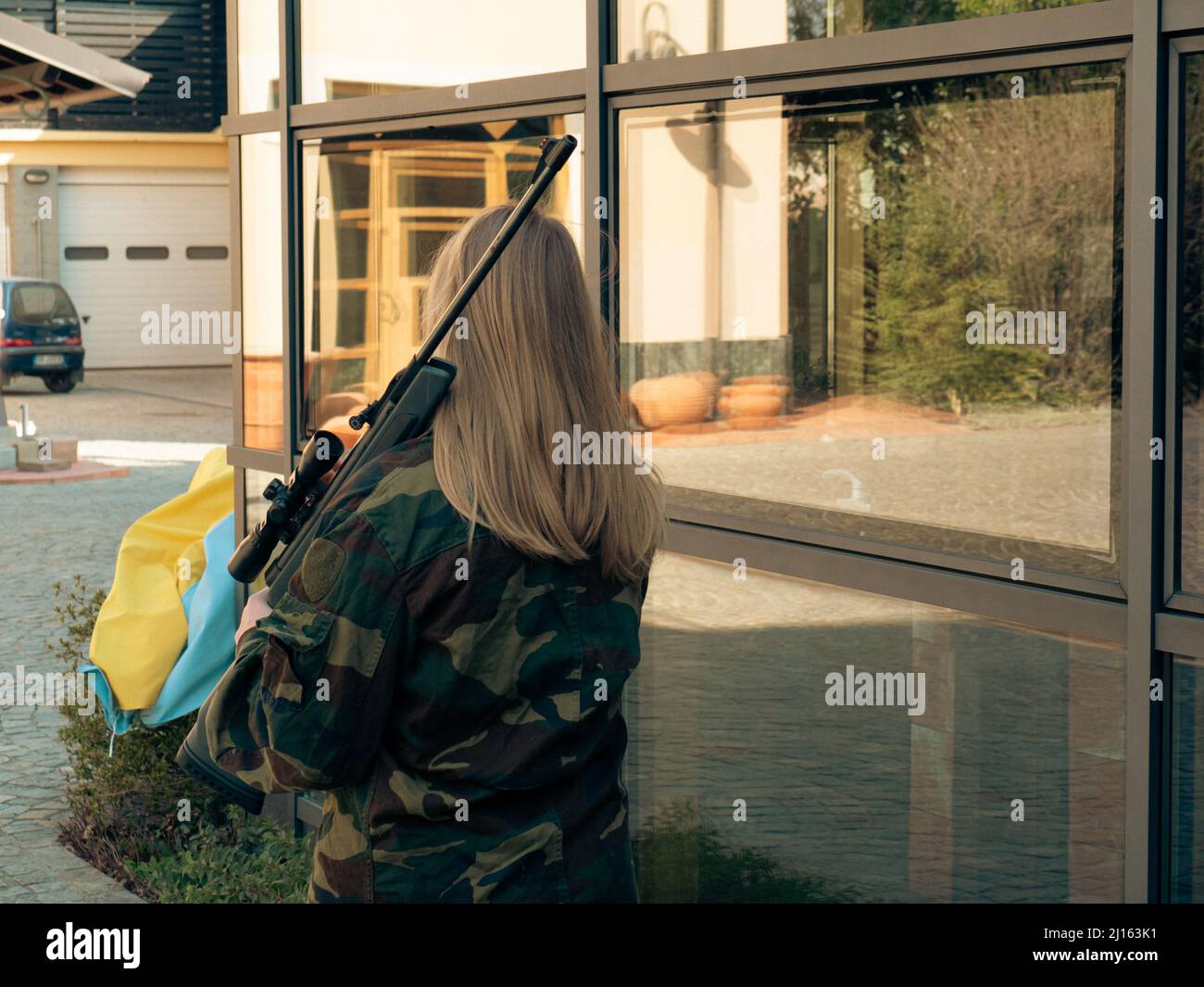 caucasian blond teen aged soldier girl on a checkpoint holding a rifle ...