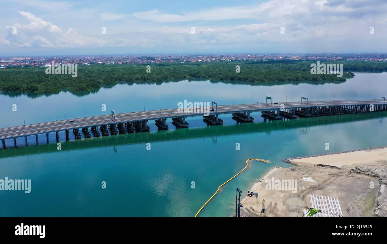Aerial view of Bali Mandara toll road over sea. Car, motorbike bridge ...