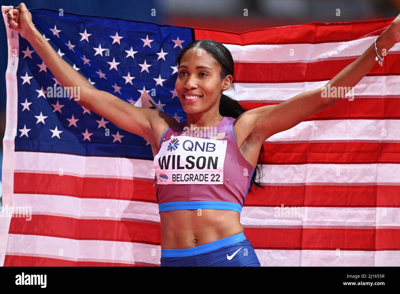 Ajee Wilson celebrating her victory with her flag at the Belgrade 2022 ...