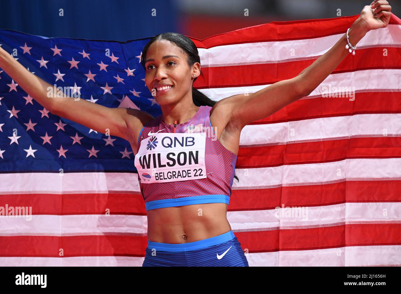 Ajee Wilson celebrating her victory with her flag at the Belgrade 2022 ...