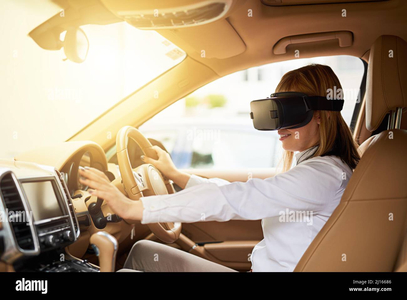 Its just like driving for real. Shot of a young businesswoman wearing a ...