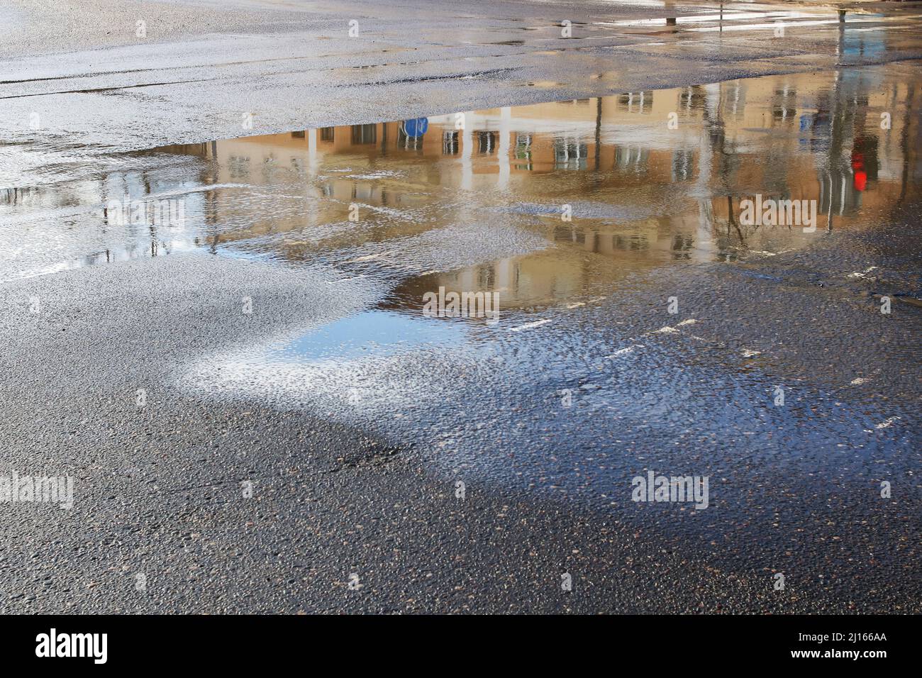 Reflection of city in puddle on pavement Stock Photo - Alamy