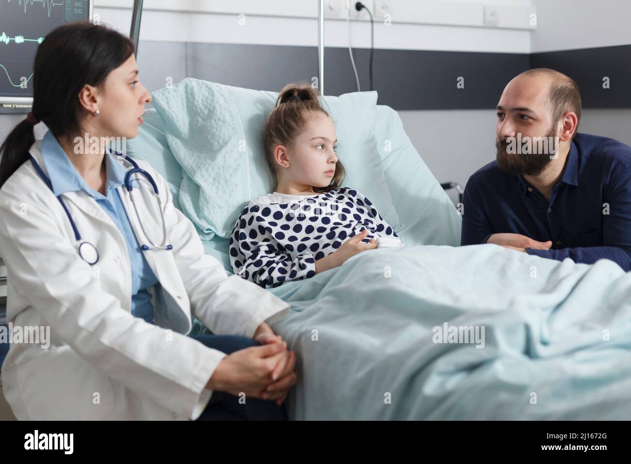 Father talking to pediatrist expert about recovery therapy while in ...