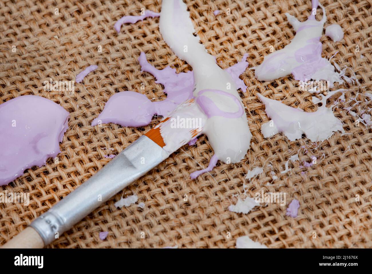 rustic hessian surface with pastel paint splatter and craft supplies ...