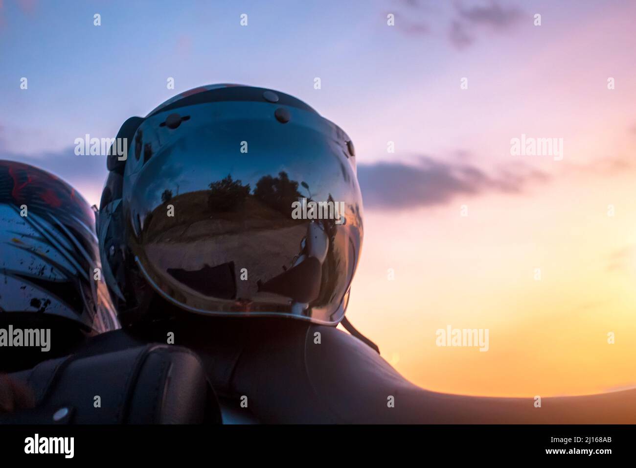 Motorcycle helmet on sunset background. Mirror visor Stock Photo - Alamy