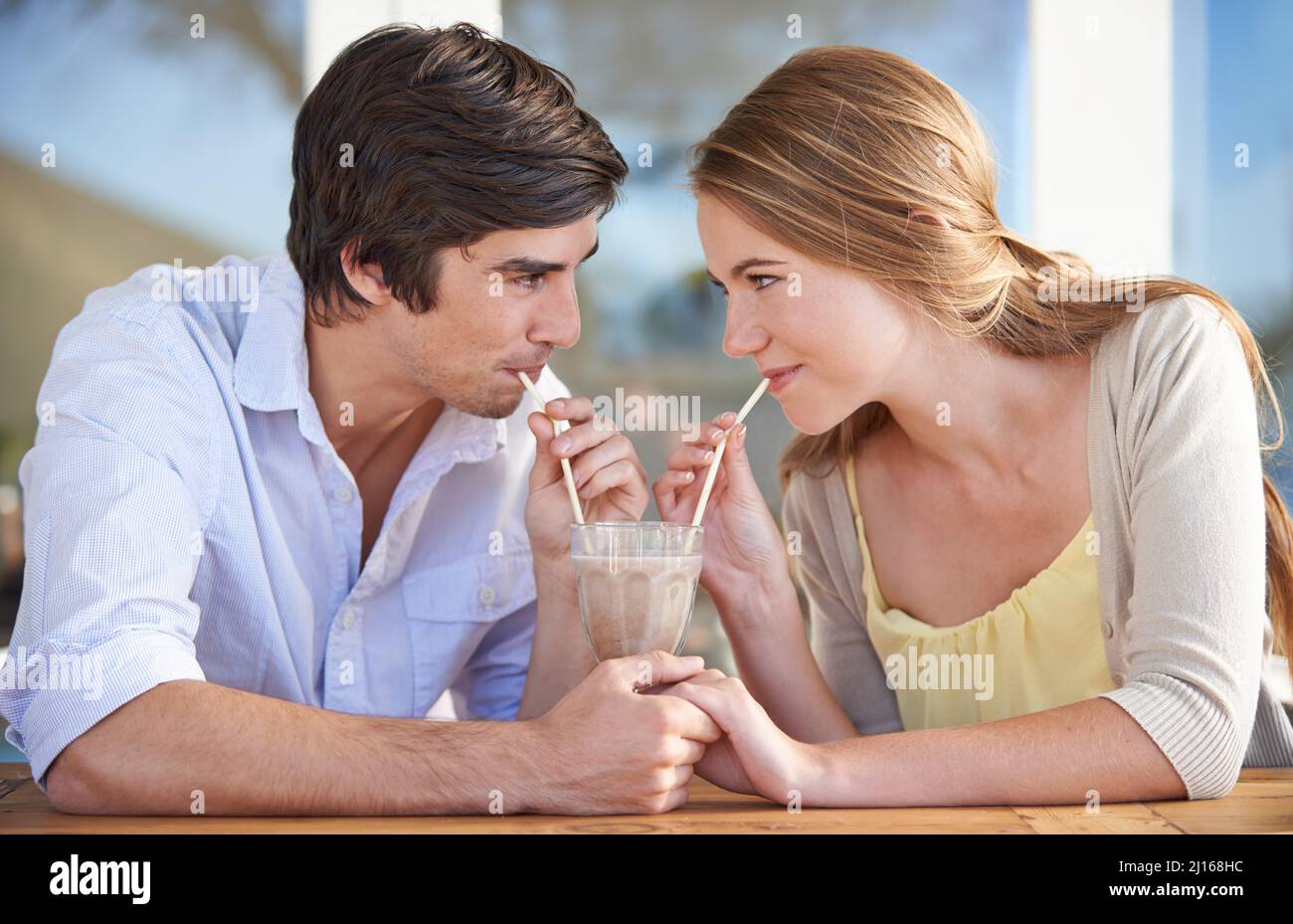 Young couple sharing milkshake hi-res stock photography and images - Alamy