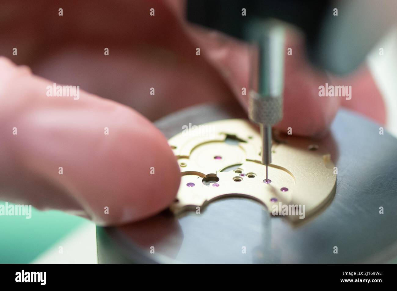 25 February 2022, Saxony, Glashütte: Sarah Westermann uses a dial gauge ...