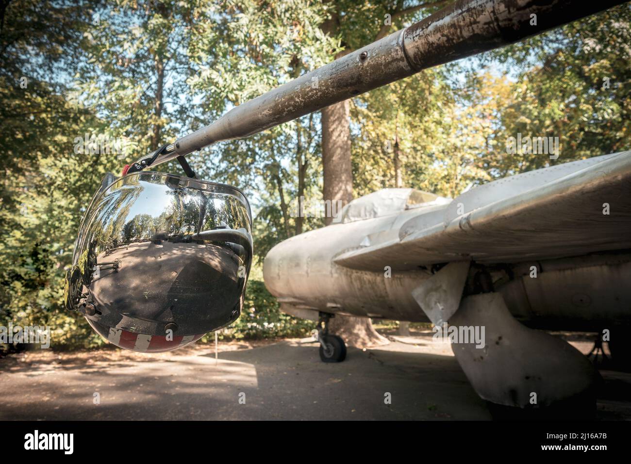 The helmet hangs on the wing of a supersonic aircraft. Mirror visor ...
