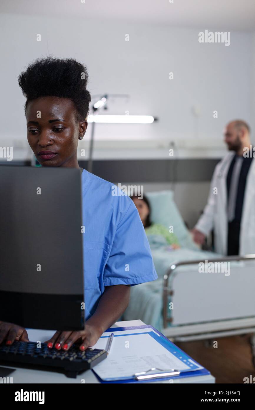 Portrait of african american health care worker using personal computer ...