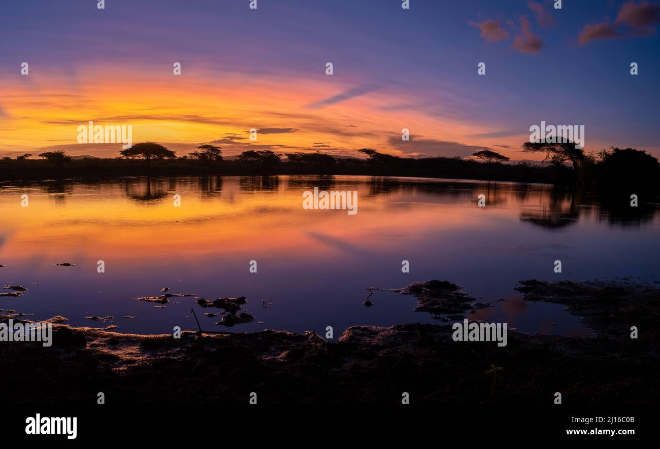 sunset by a water pool lake in the Savannah of South Africa Kwazulu ...