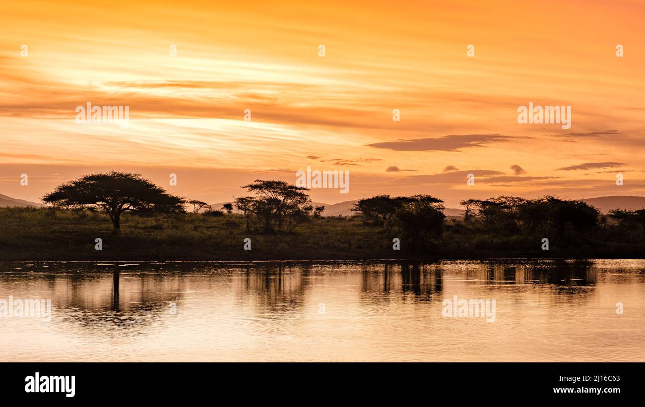 sunset by a water pool lake in the Savannah of South Africa Kwazulu ...