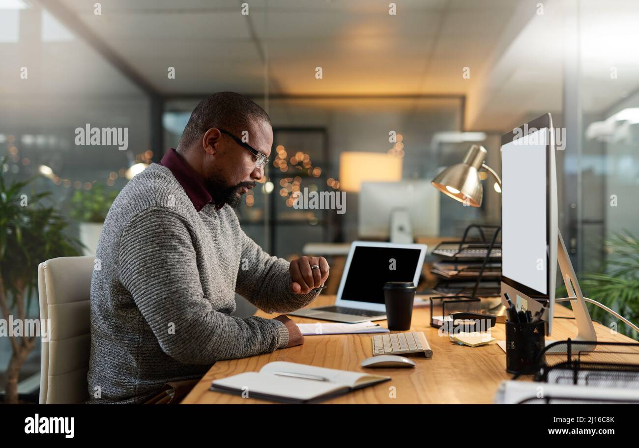 Working at his desk looking at notice hi-res stock photography and ...