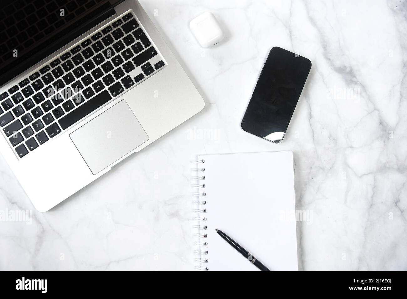 Overhead of laptop computer, mobile phone and notebook Stock Photo - Alamy