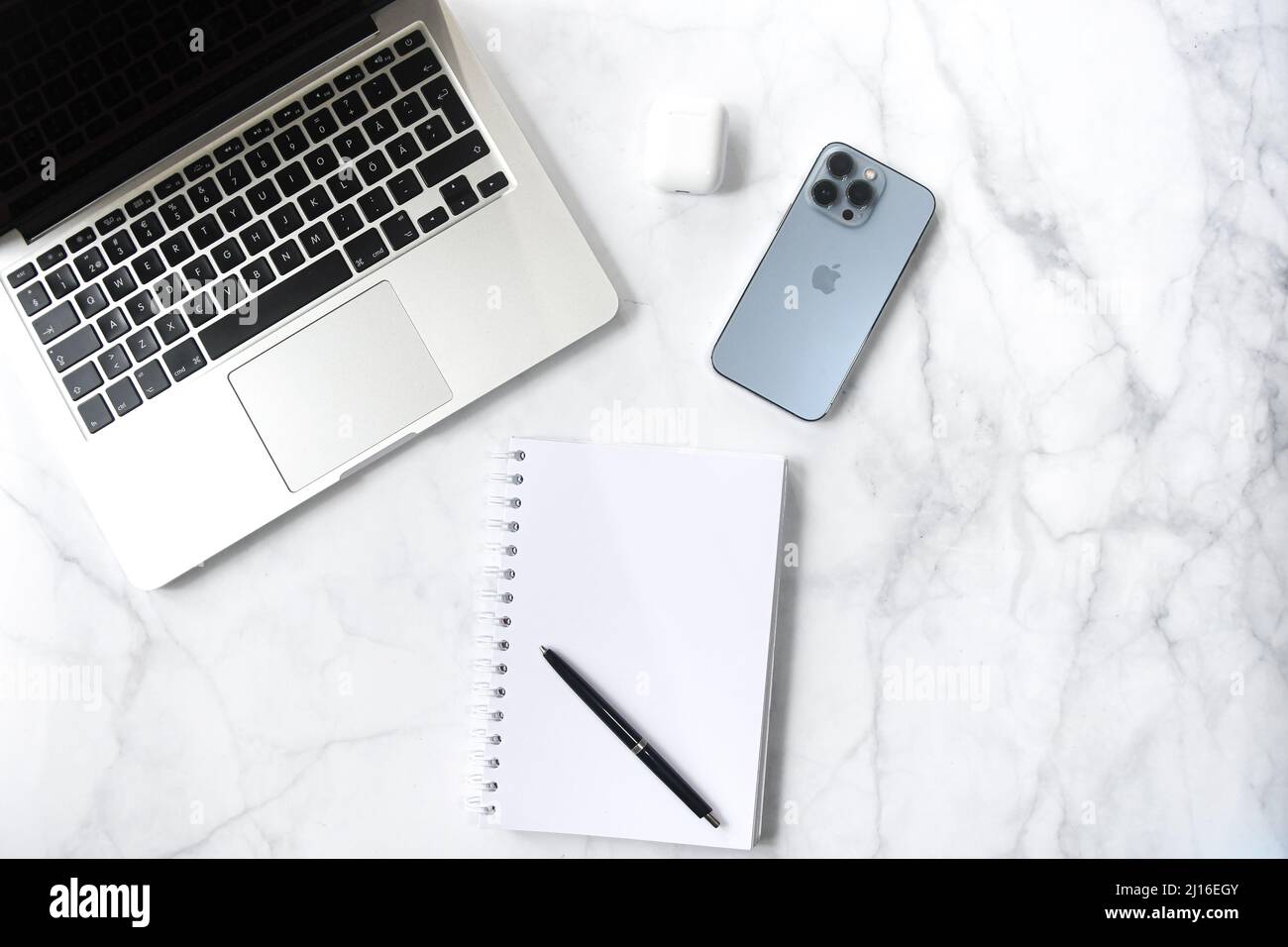 Overhead of laptop computer, mobile phone and notebook Stock Photo - Alamy