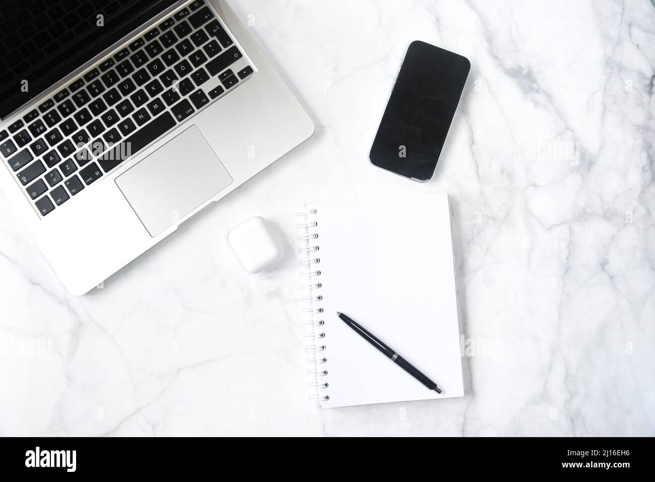 Overhead of laptop computer, mobile phone and notebook Stock Photo - Alamy