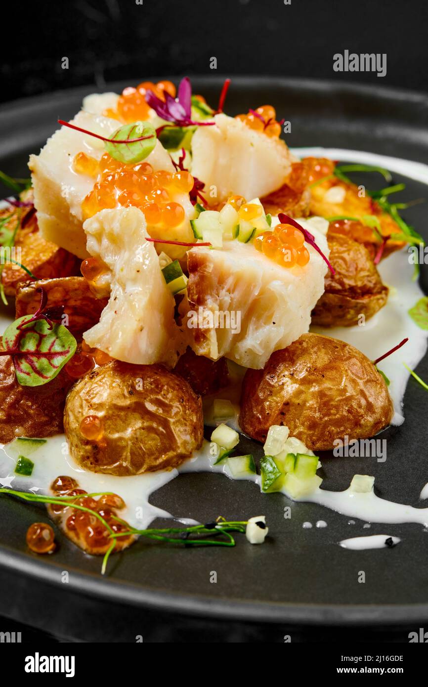 Roasted cod fillet with deep fried spring potato Stock Photo - Alamy