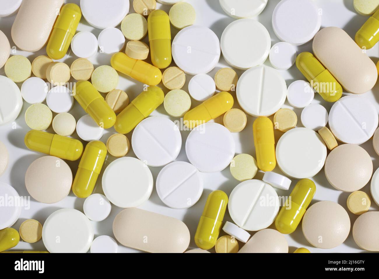Pills and capsules of different shapes and sizes are isolated on a ...