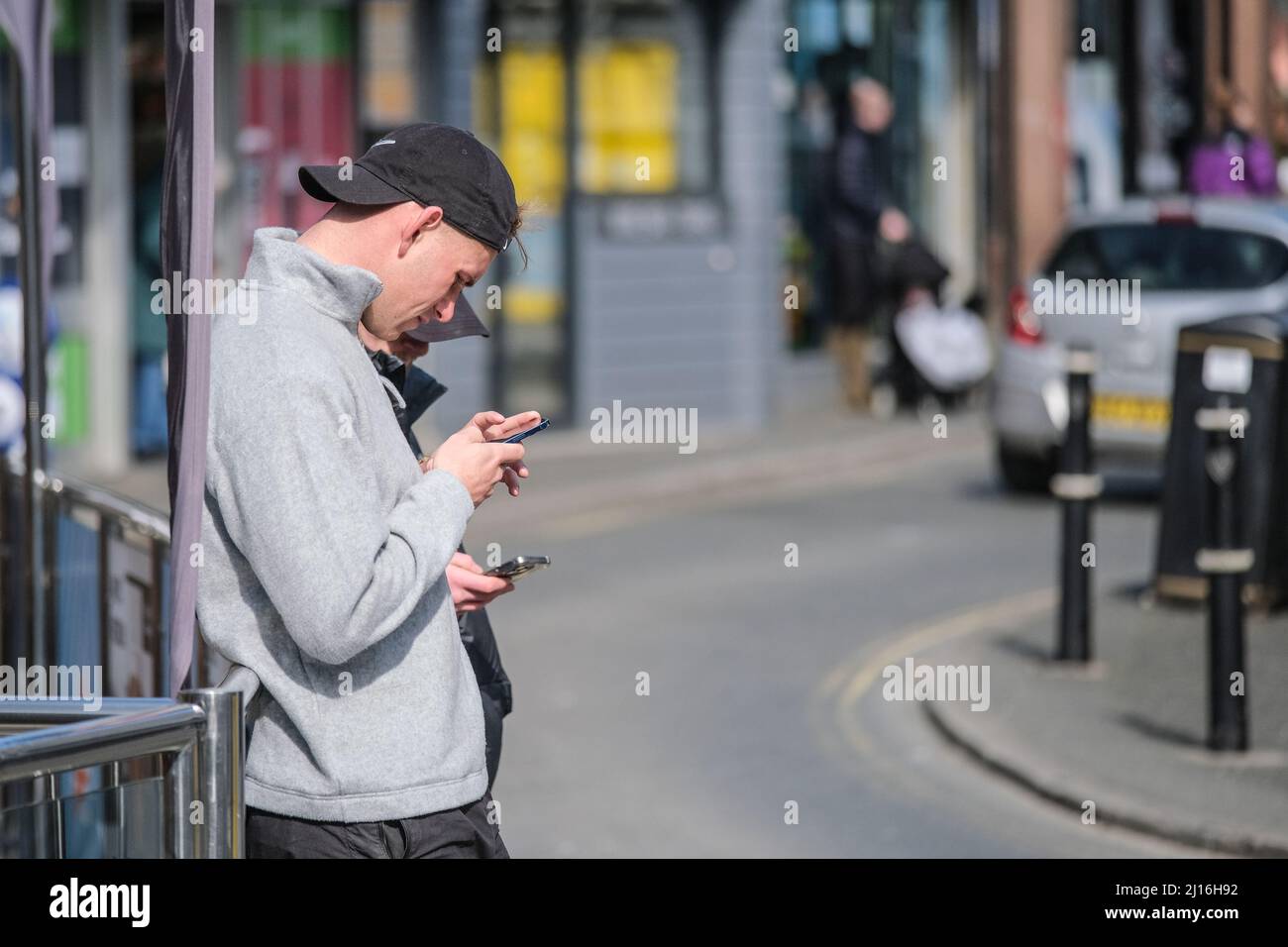 Men checking their mobile phones Stock Photo - Alamy