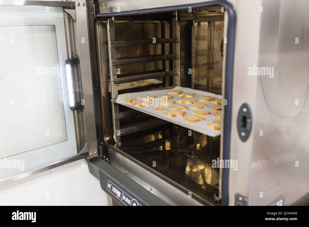 Freshly baked cookies inside the bakery oven Stock Photo - Alamy