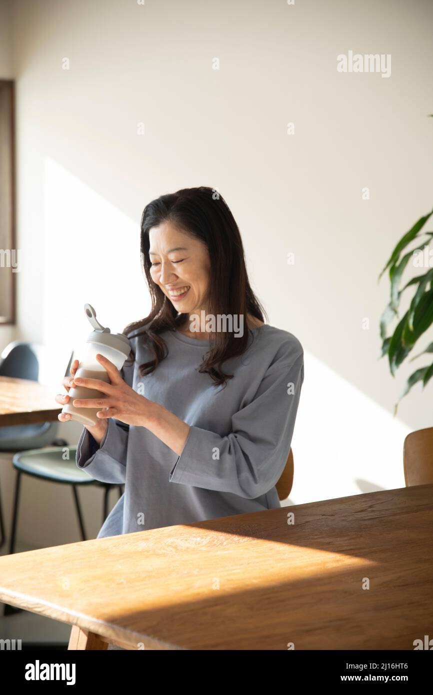 Woman Drinking Protein Drink Stock Photo - Alamy