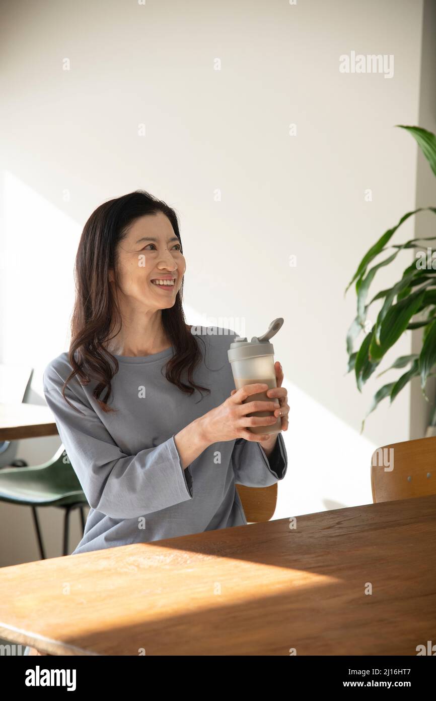 Woman Drinking Protein Drink Stock Photo - Alamy