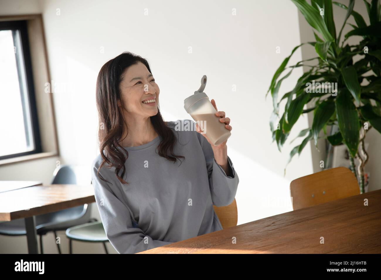Woman Drinking Protein Drink Stock Photo - Alamy
