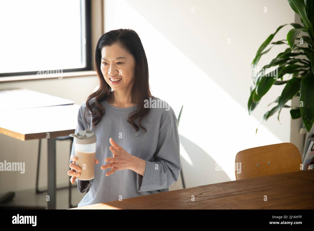 Woman Drinking Protein Drink Stock Photo - Alamy