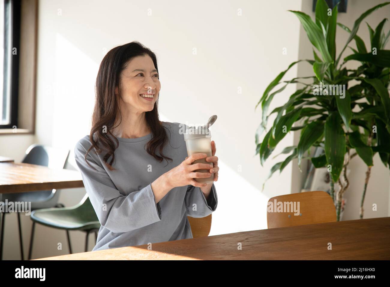 Woman Drinking Protein Drink Stock Photo - Alamy