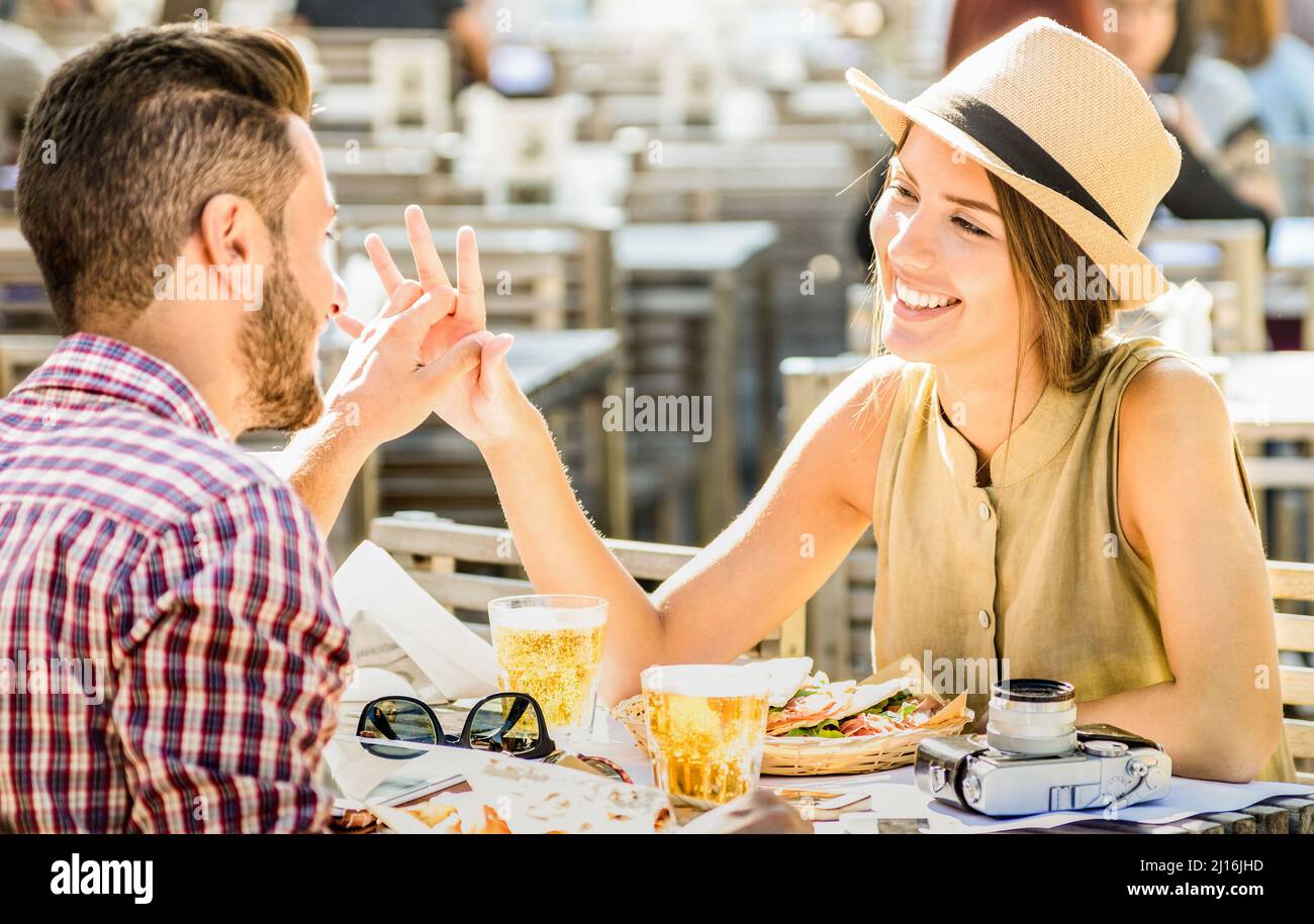 Couple in love having fun at beer bar on travel excursion - Young happy ...