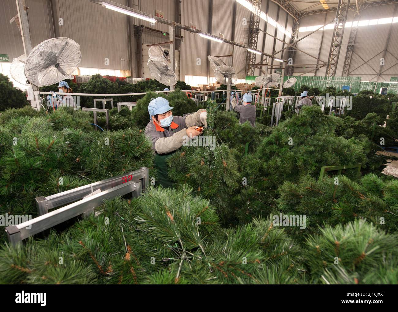 HUAI'AN, CHINA - MARCH 23, 2022 - A worker produces an export Christmas ...