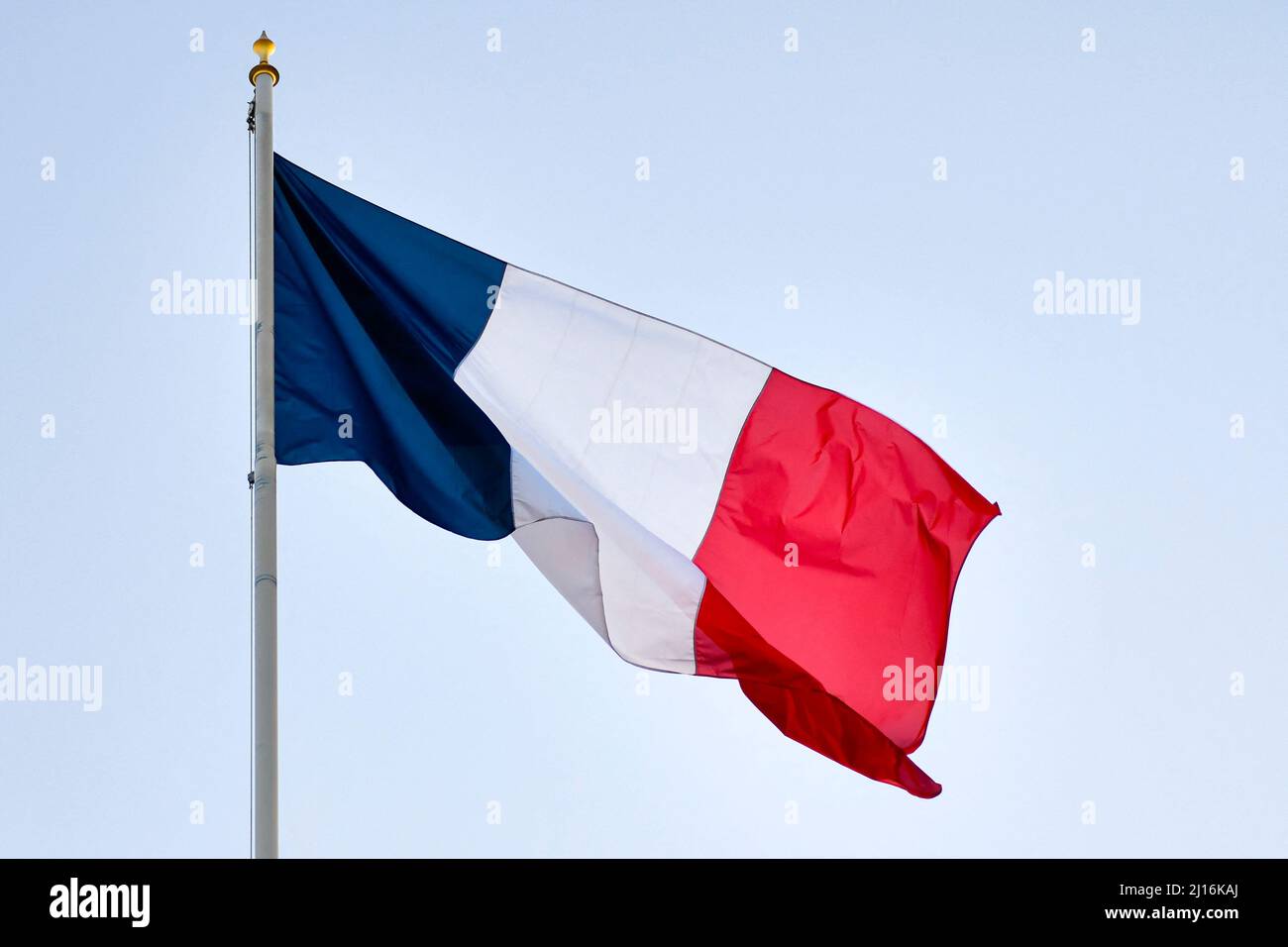 A French flag (blue white and red) flies inside the courtyard to the ...