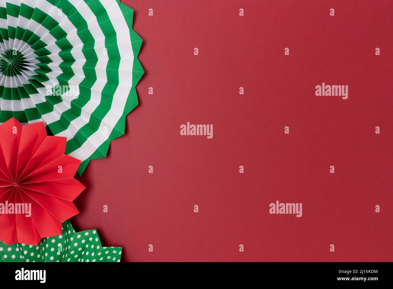 Border frame made of paper fans. Red and green decorations with copy ...